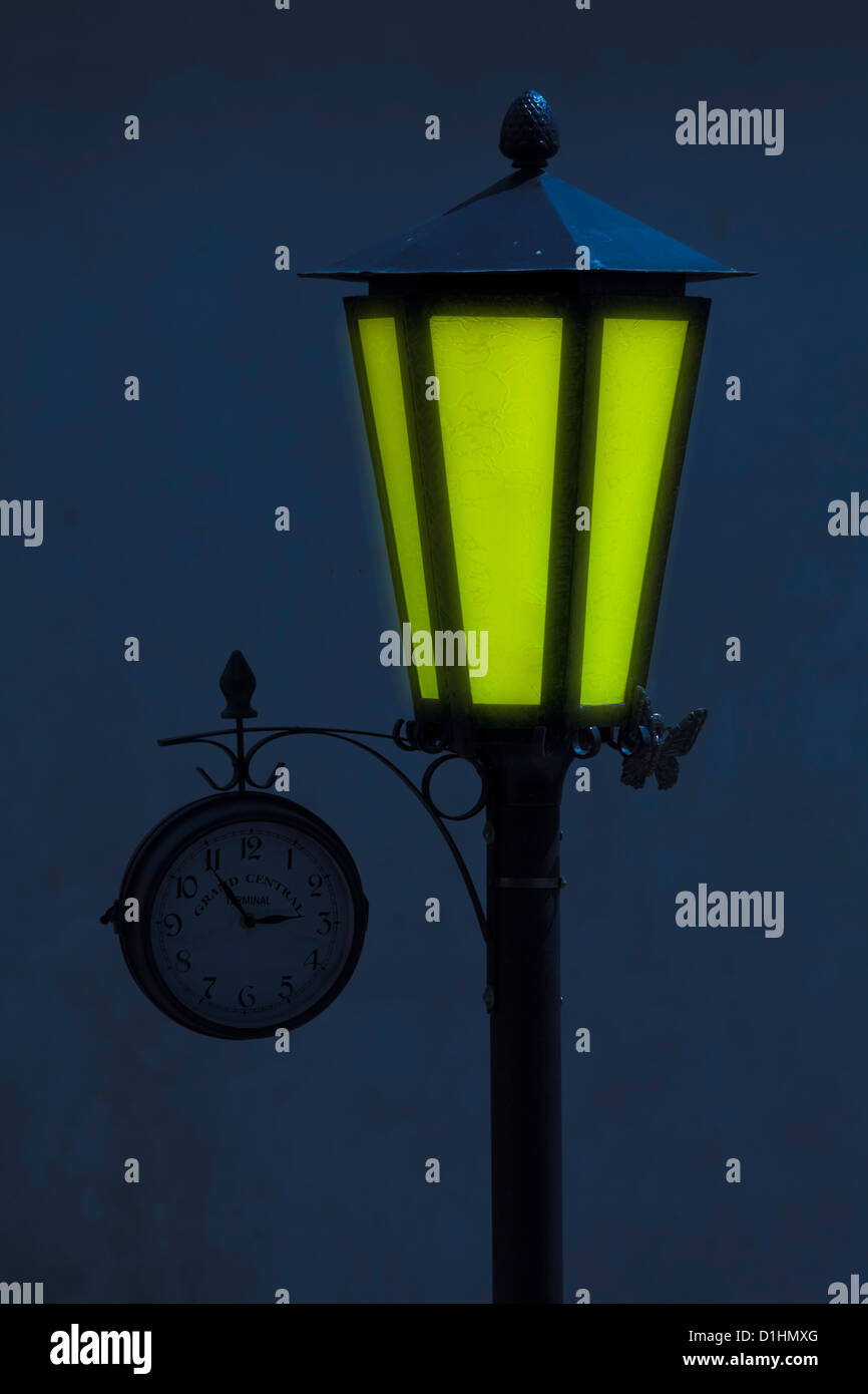 Street lamppost and clocks with night light Stock Photo - Alamy