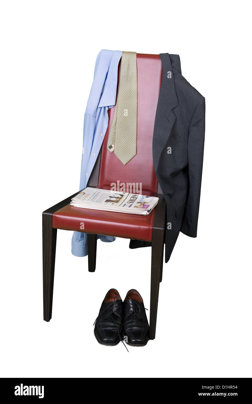 clothes and newspaper on the chair Stock Photo - Alamy