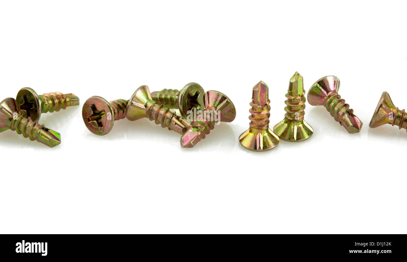 small yellow screws on a white background Stock Photo - Alamy