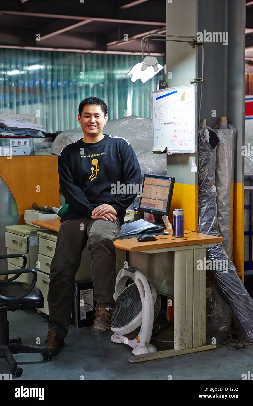 A worker at a textile lab poses next to a computer Stock Photo - Alamy