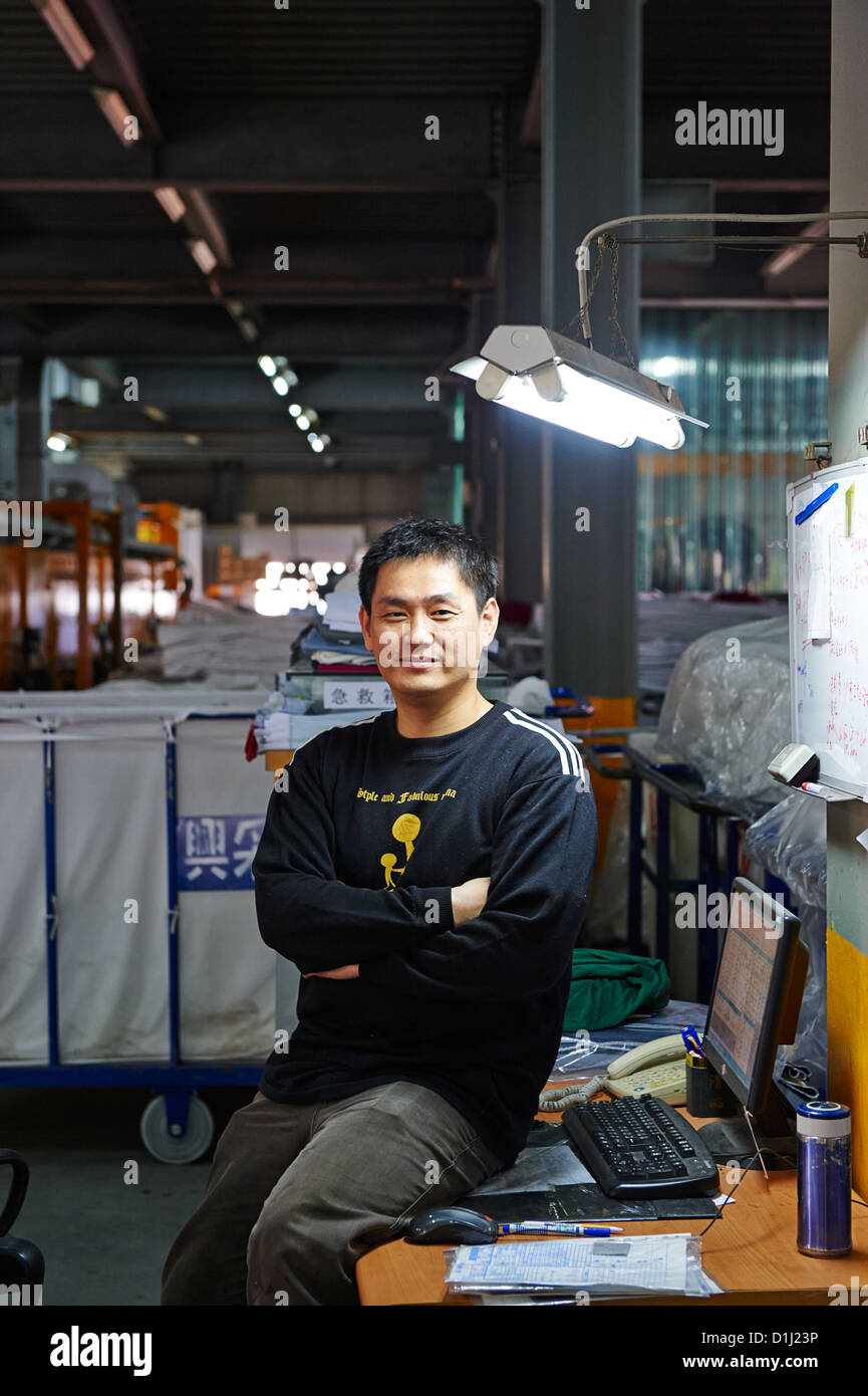 A worker at a textile lab poses next to a computer Stock Photo - Alamy