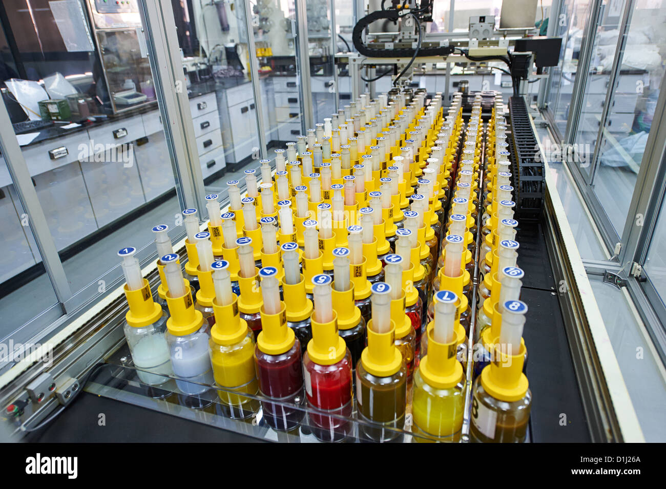 A worker adjusts a color dying machine at factory and research ...