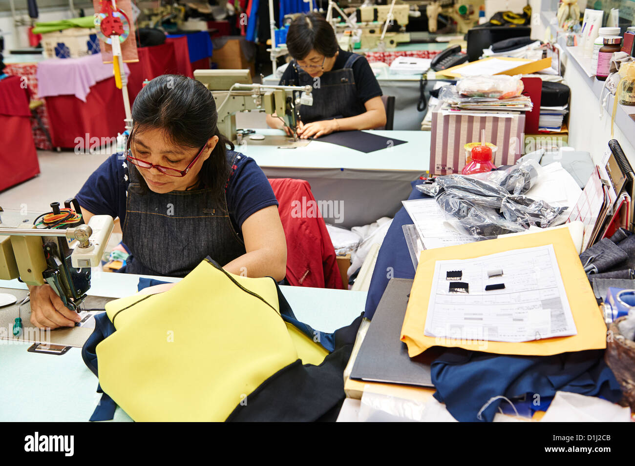 Women sewing in factory and research laboratory where fabric is ...