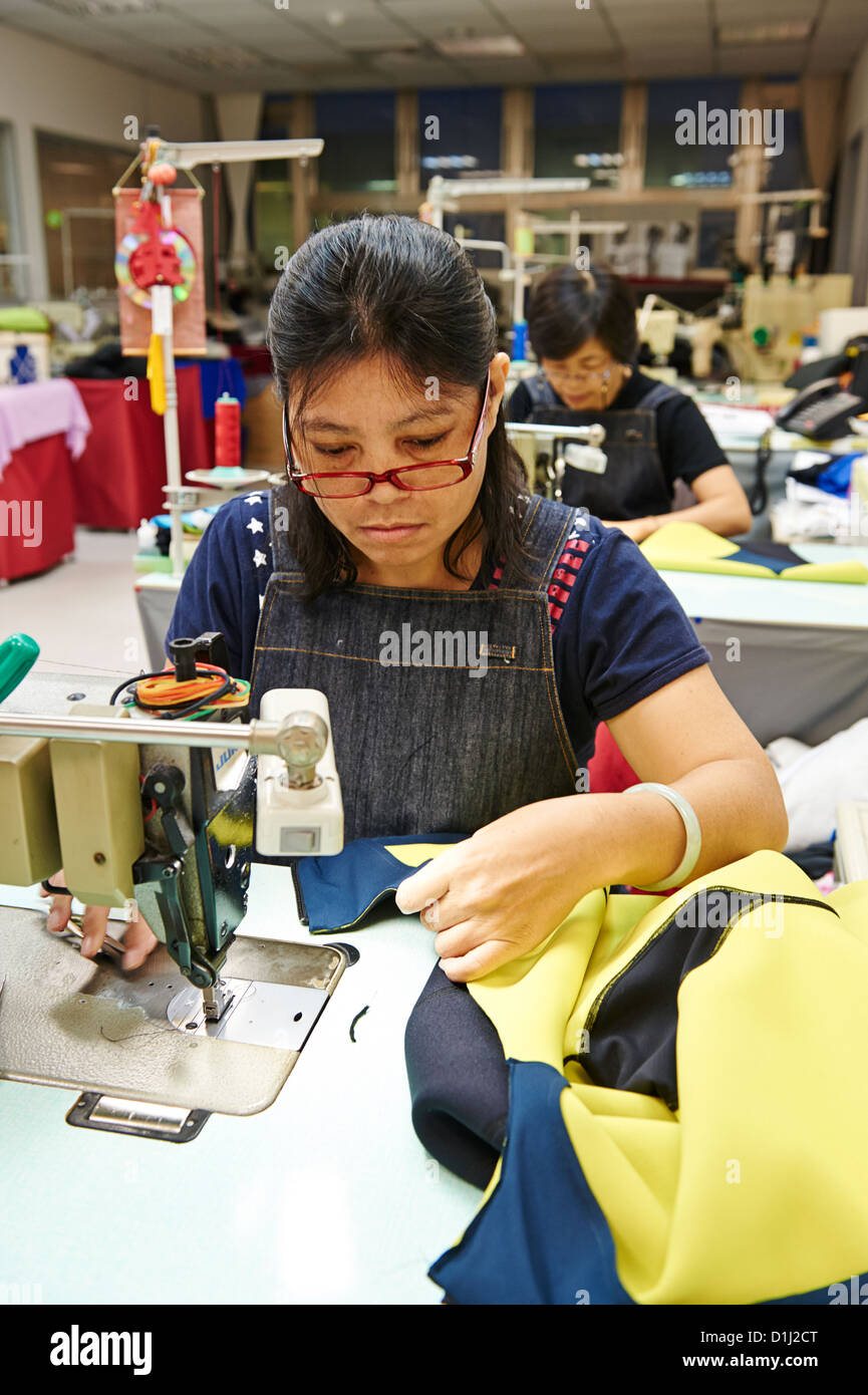 Women sewing in factory and research laboratory where fabric is ...