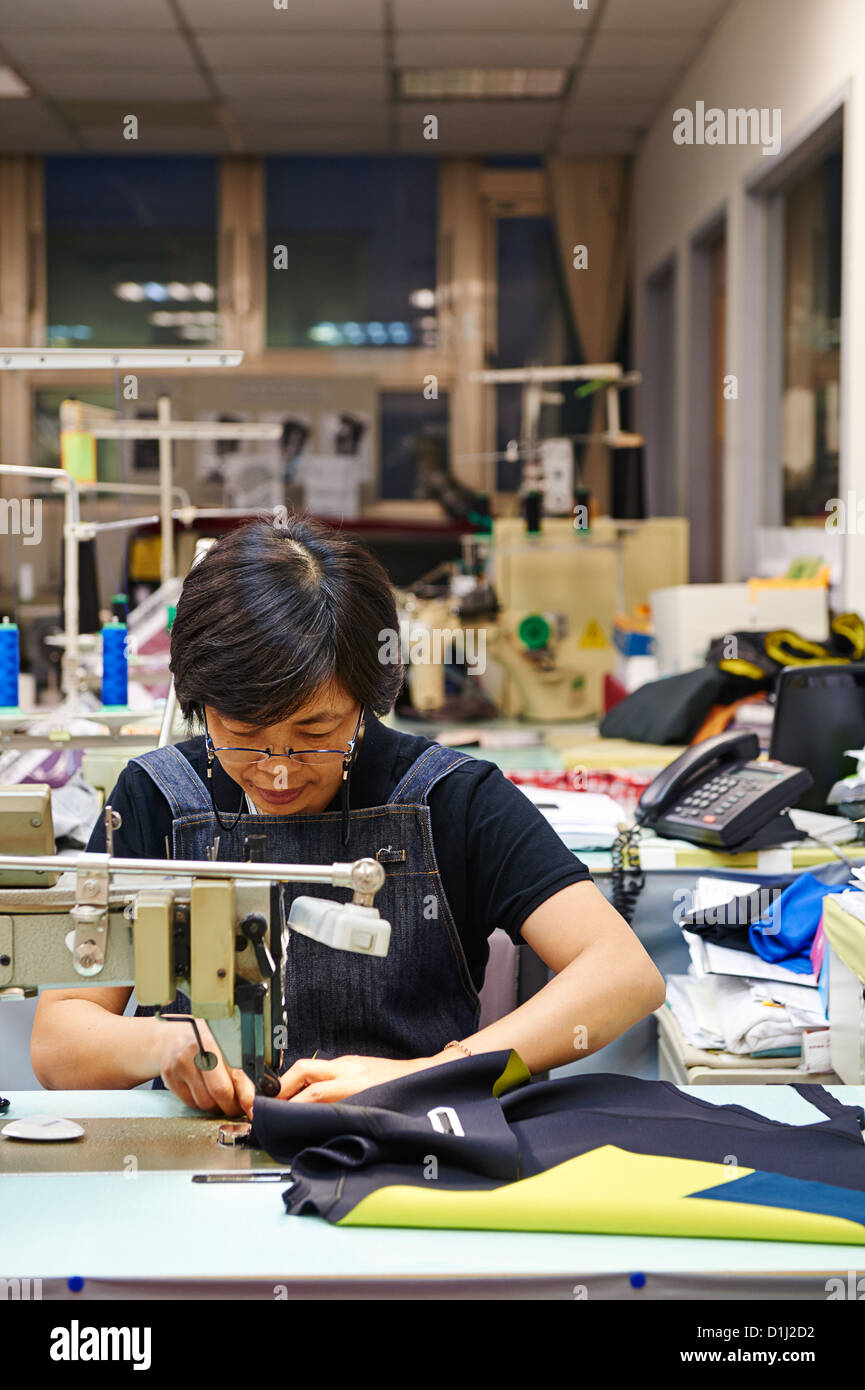 Women sewing in factory and research laboratory where fabric is ...
