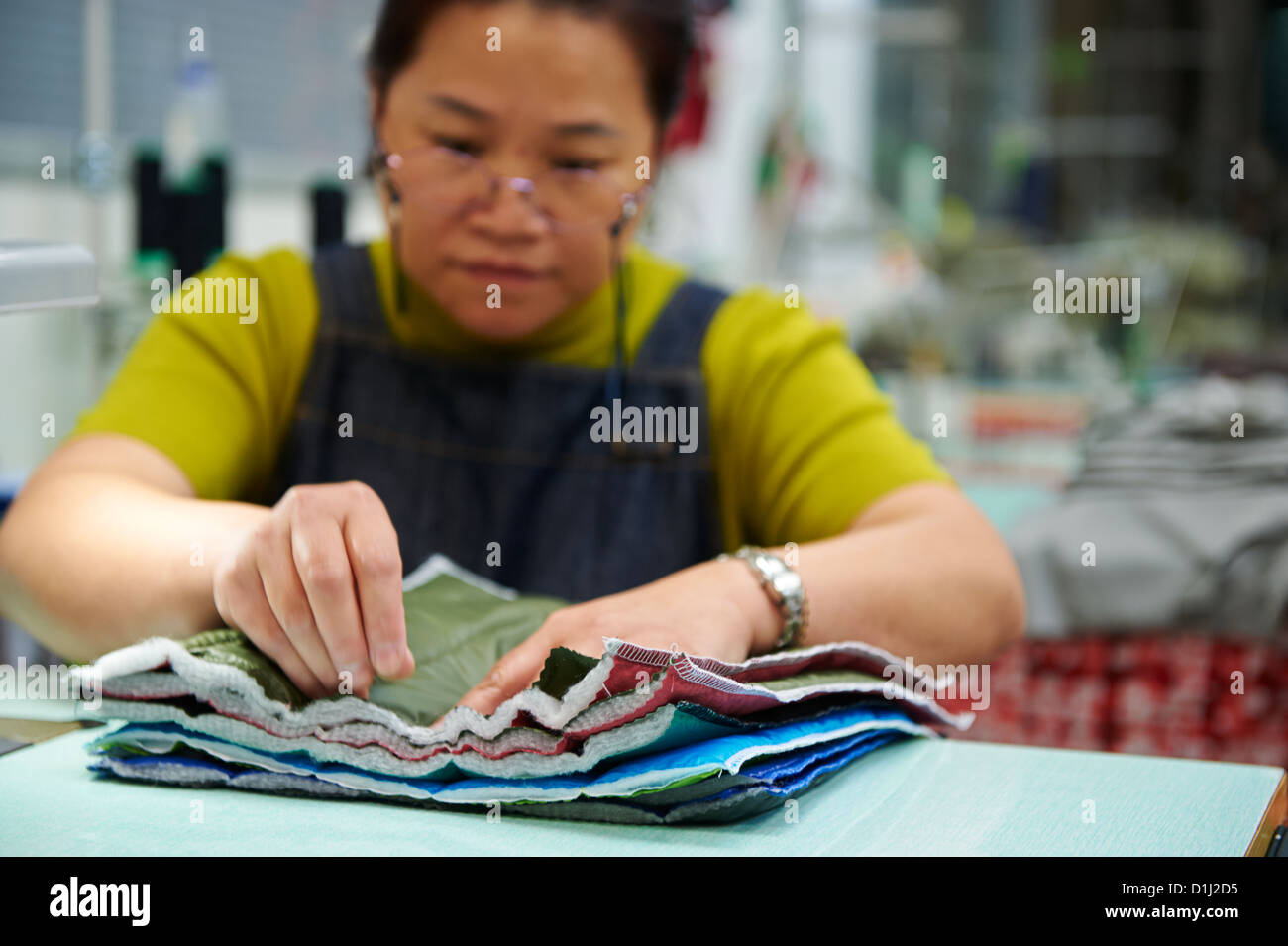 Women sewing in factory and research laboratory where fabric is ...