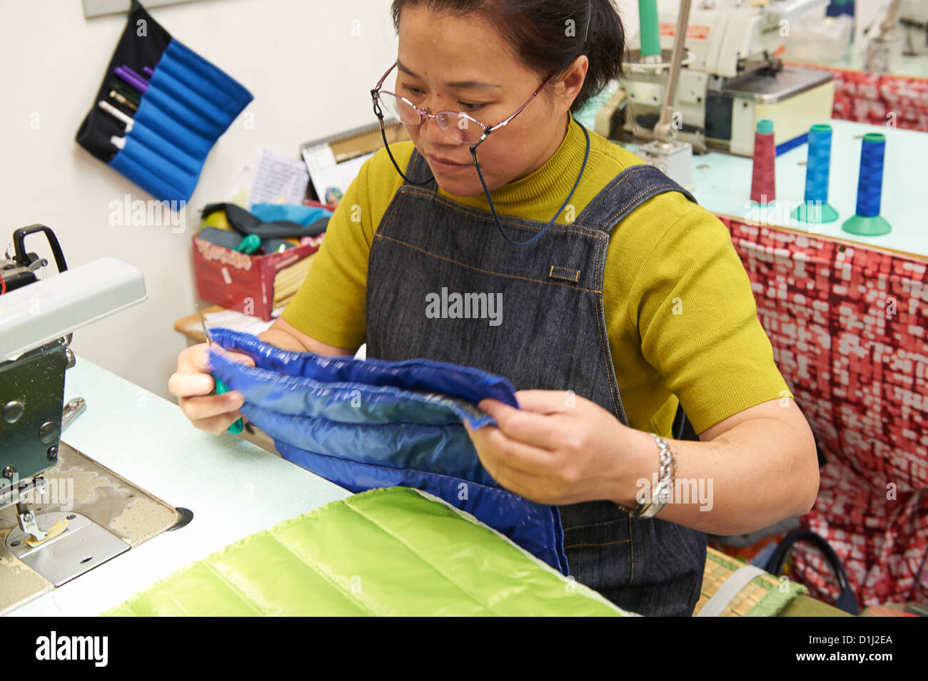 Women sewing in factory and research laboratory where fabric is ...