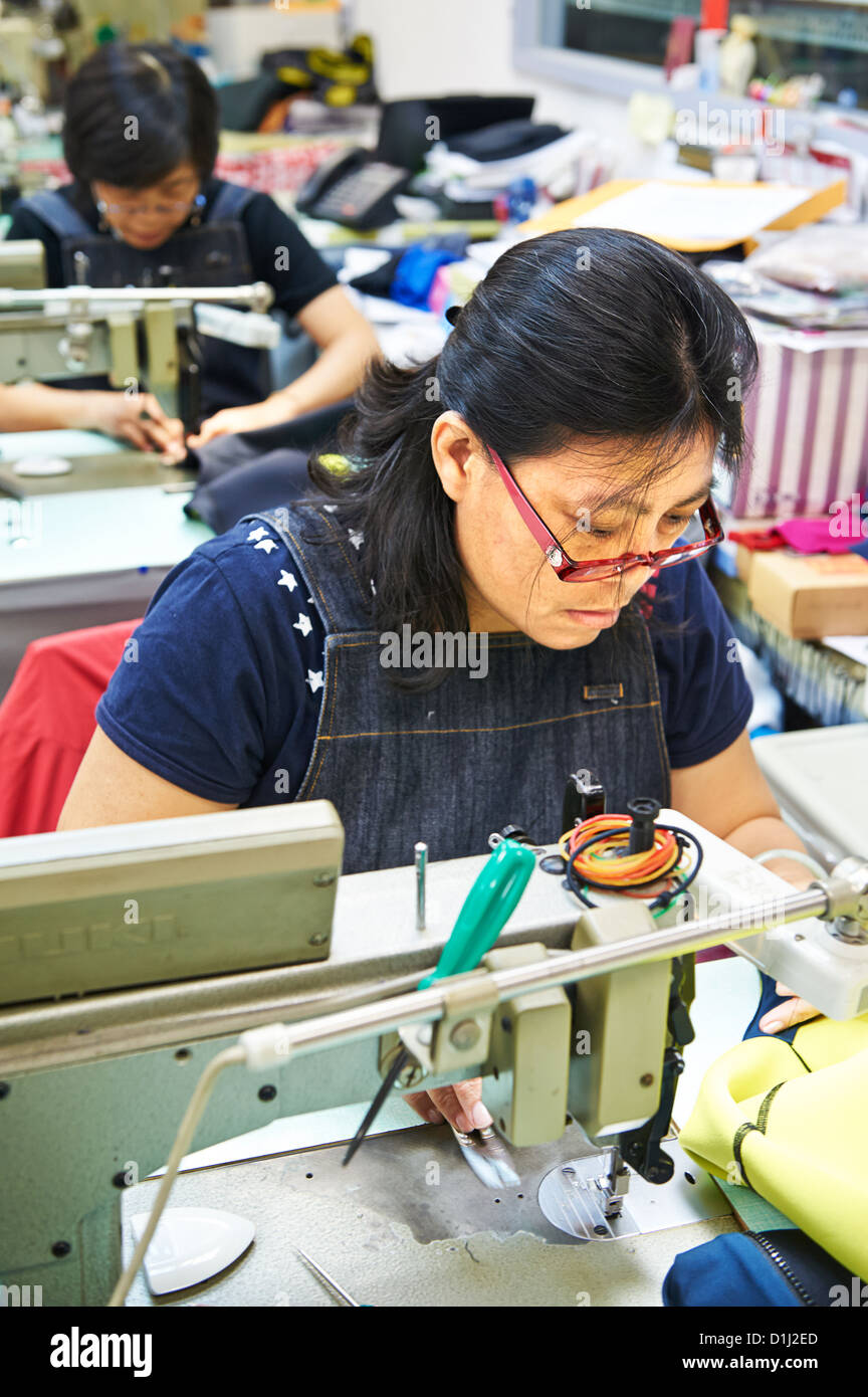 Women sewing in factory and research laboratory where fabric is ...