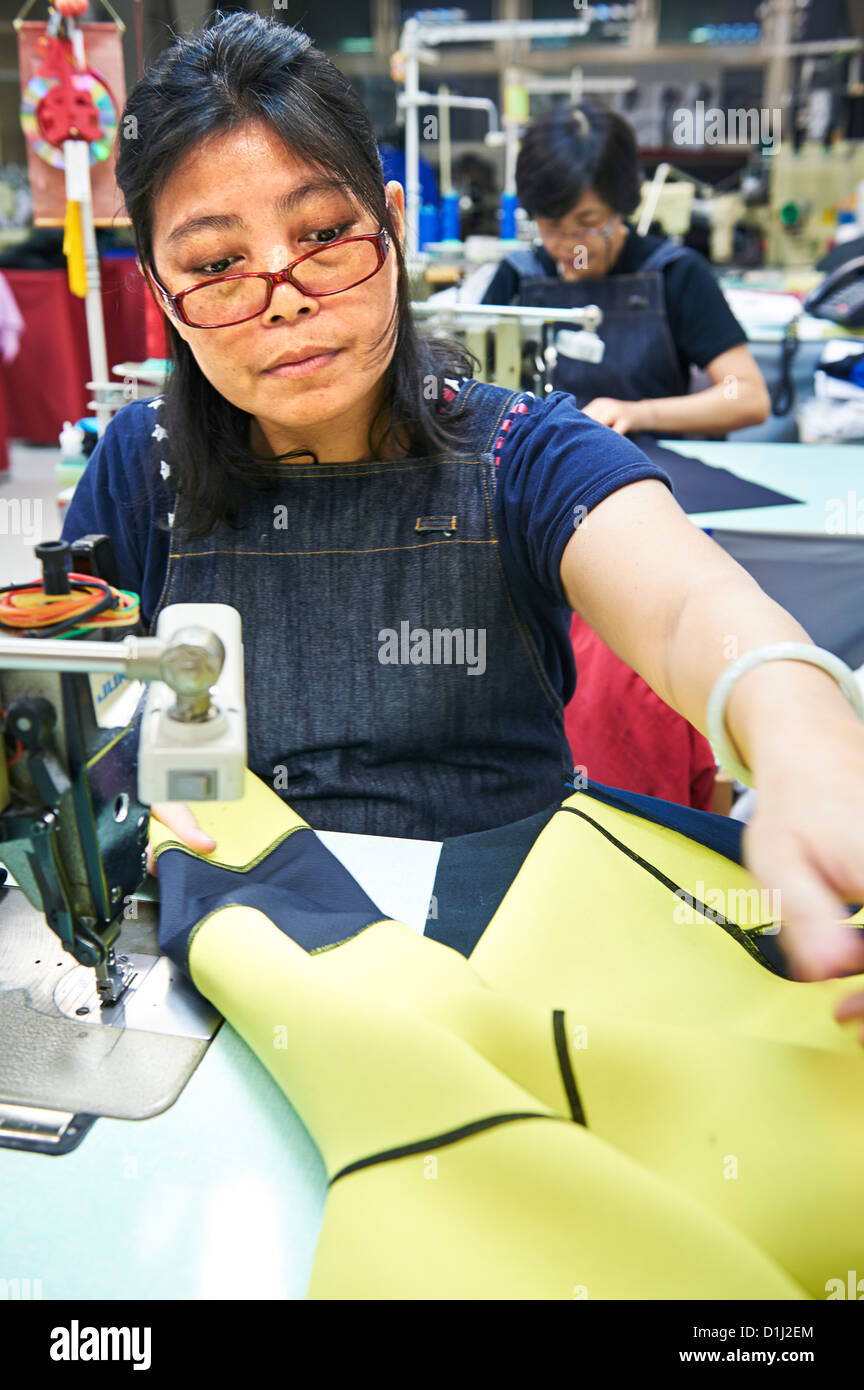 Women sewing in factory and research laboratory where fabric is ...