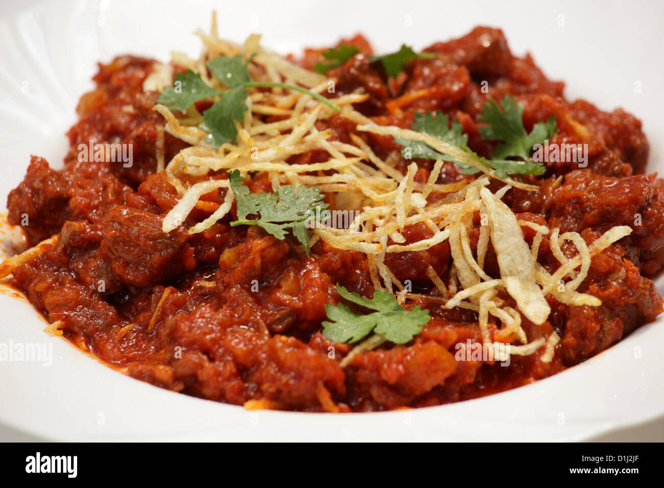 Non vegetarian Parsi dish Sallie boti Stock Photo - Alamy