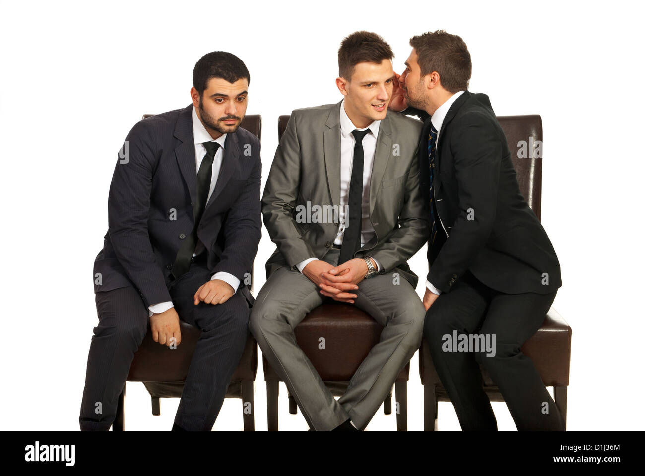 Business man sharing a secret to his colleague and the other trying to ...