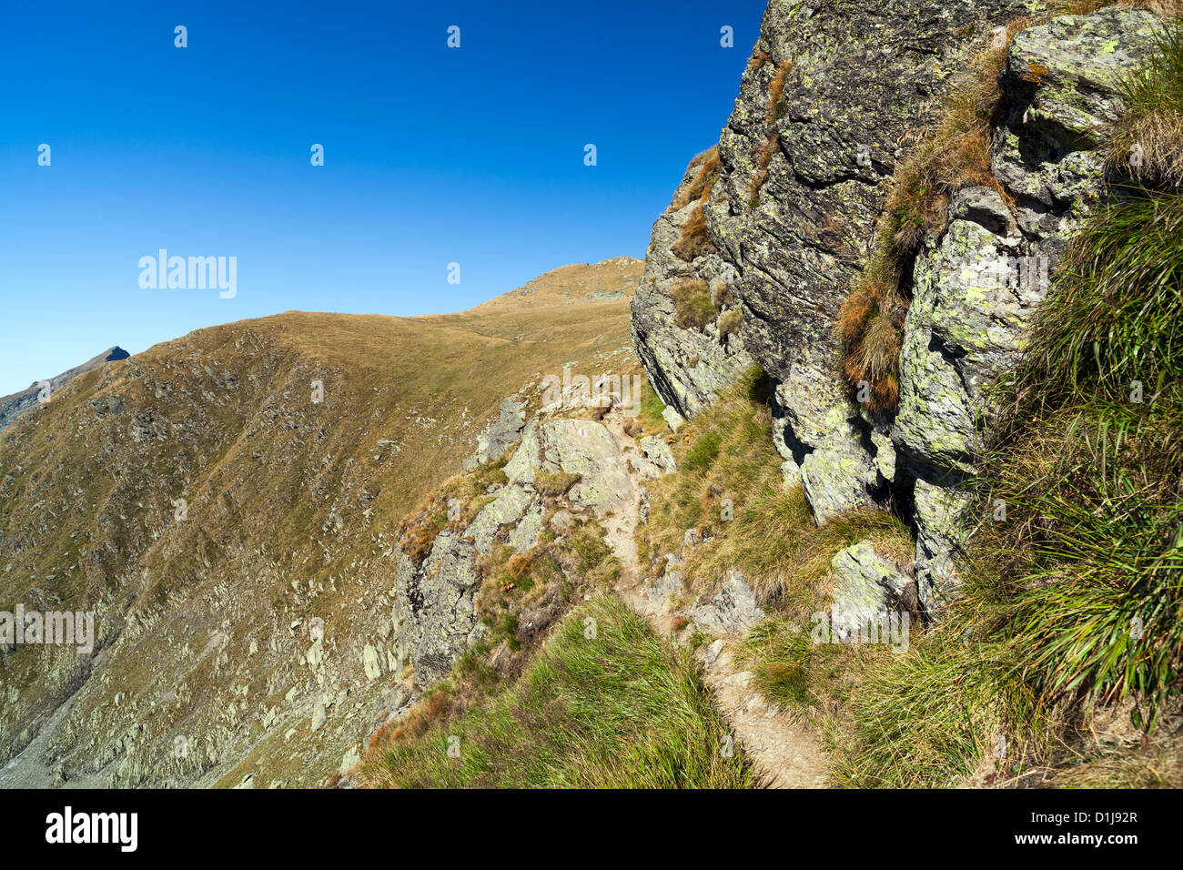Landscape with mountain trail and clear blue sky Stock Photo - Alamy