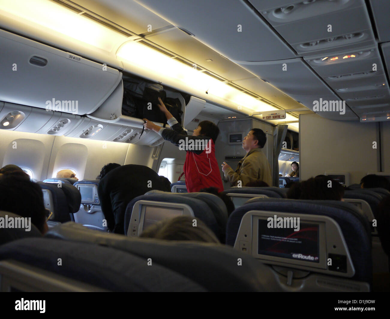 asian passenger airplane cabin baggage luggage Stock Photo - Alamy