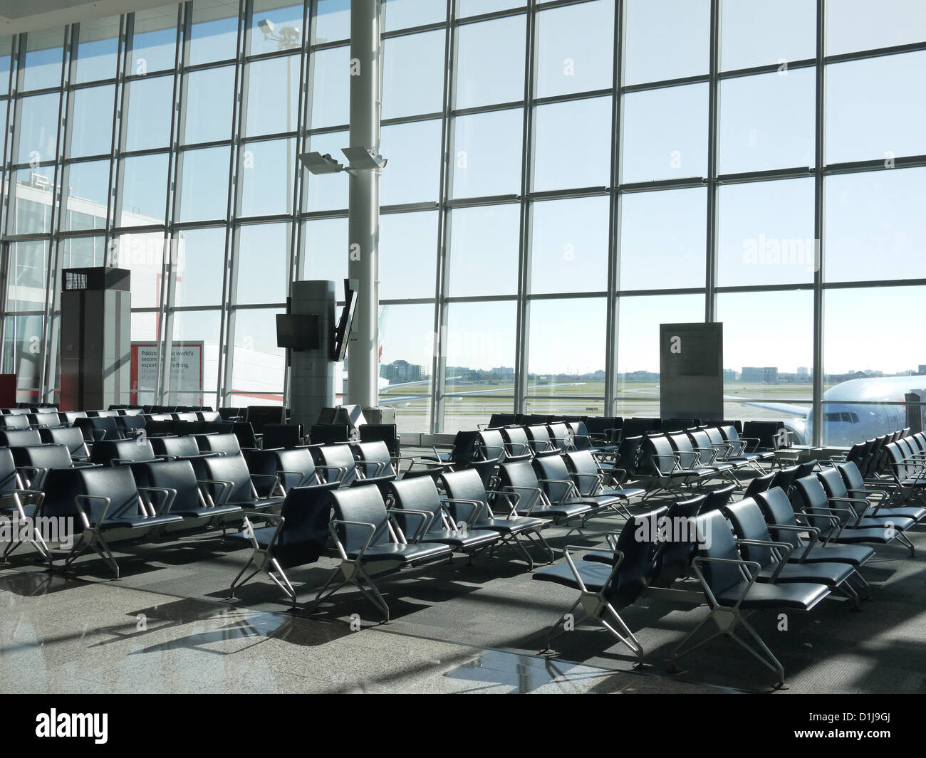 empty airport waiting area gate seats glass window Stock Photo - Alamy