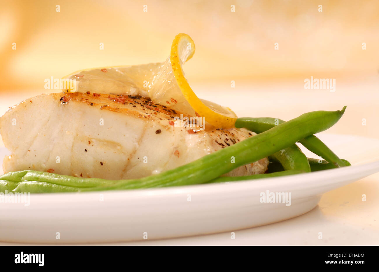 Fresh sautéed cod fillet with green beans Stock Photo - Alamy