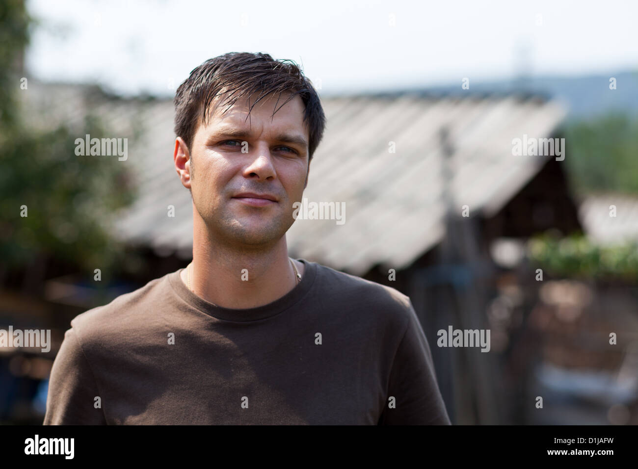 Closeup portrait of an young man outside, at countryside, in a sunny ...