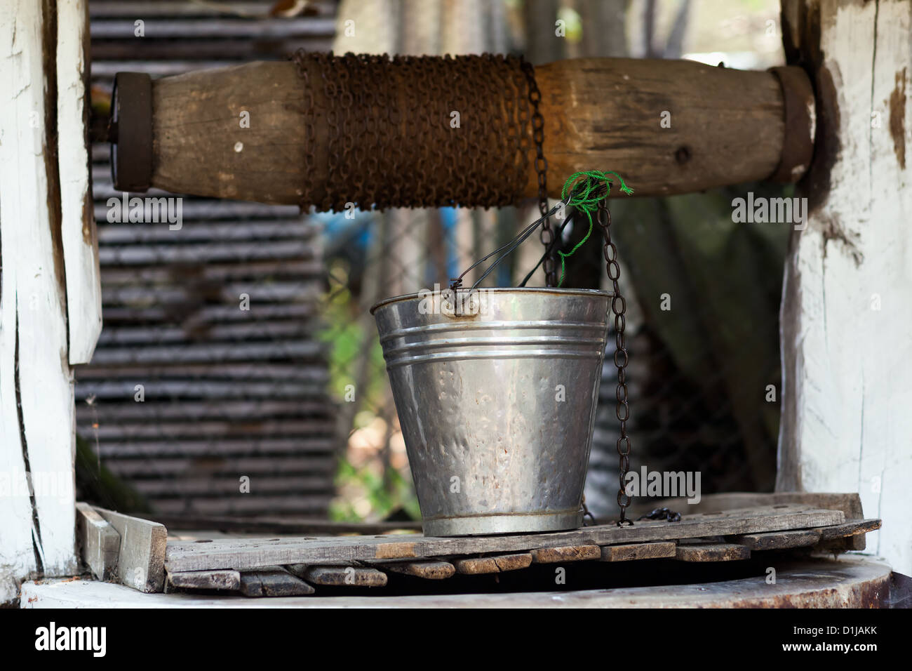 Closeup of a well with pulley and aluminium bucket Stock Photo - Alamy