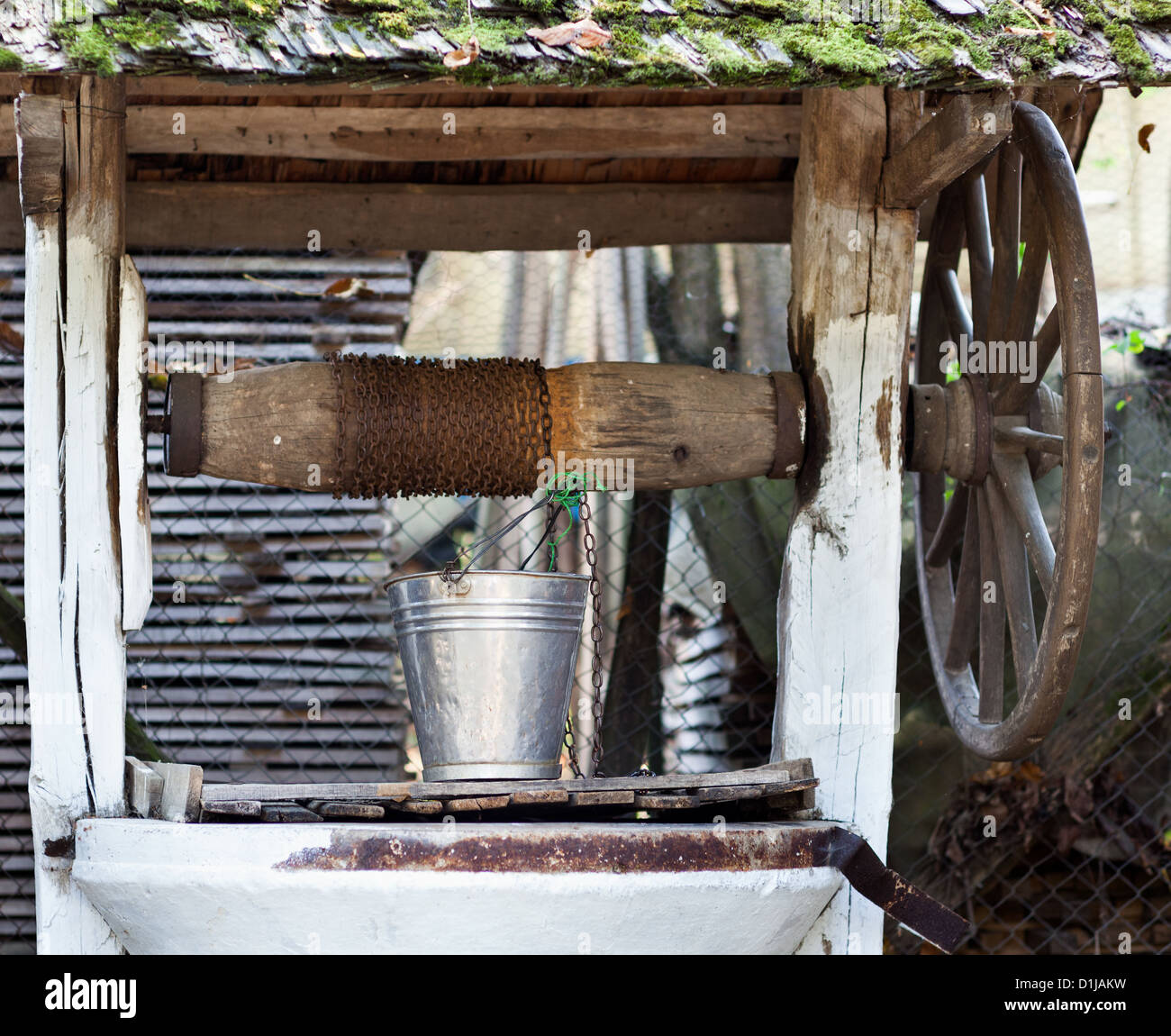 Closeup of a well with wheel, pulley and aluminium bucket Stock Photo ...