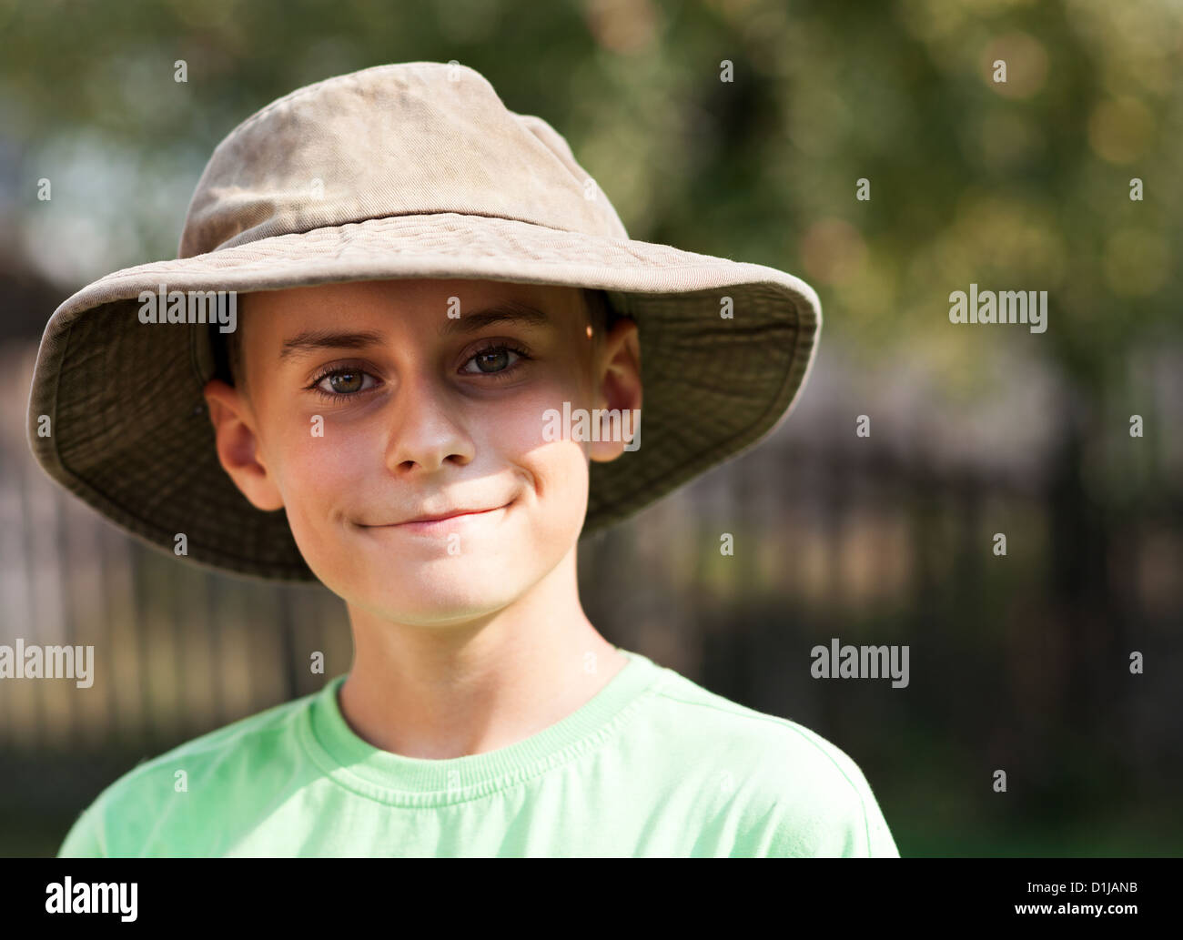 Closeup portrait of a cute schoolboy with big hat, outdoor at ...