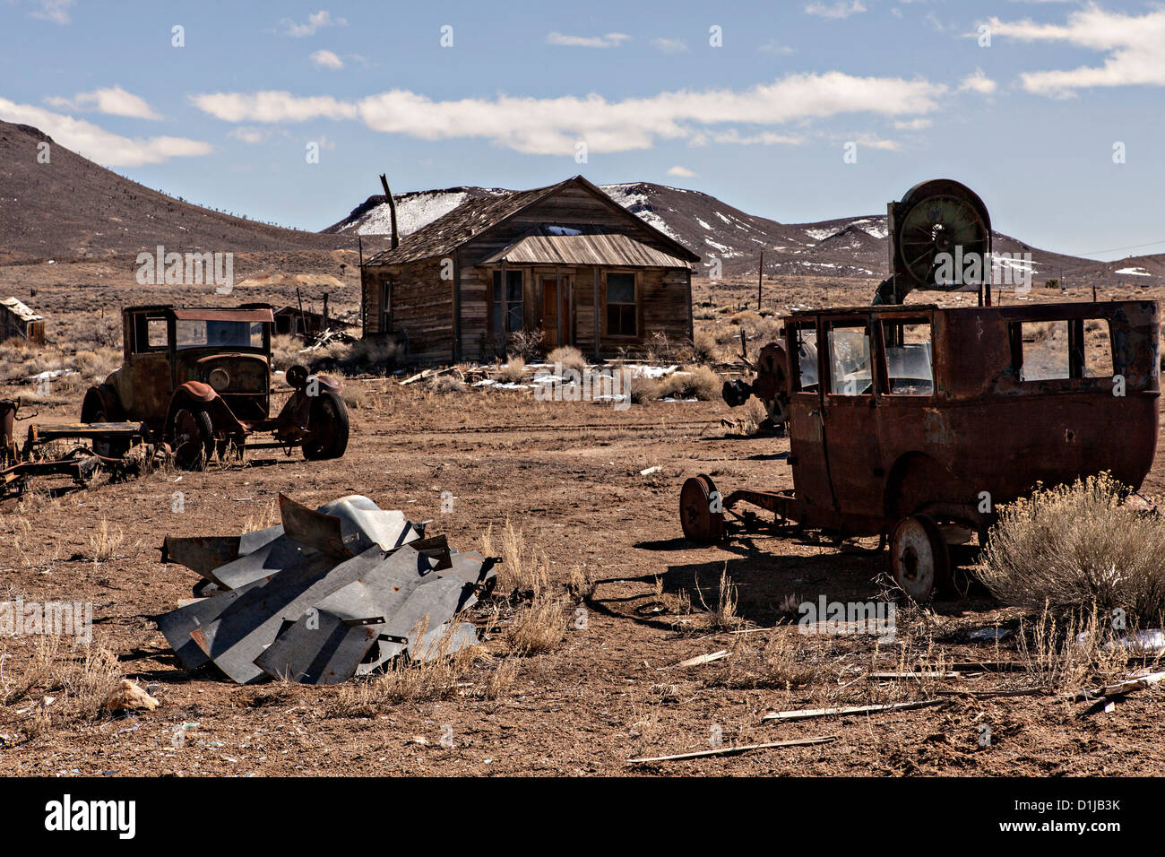 Old rusty cars and abandoned buildings in former gold mining boomtown ...