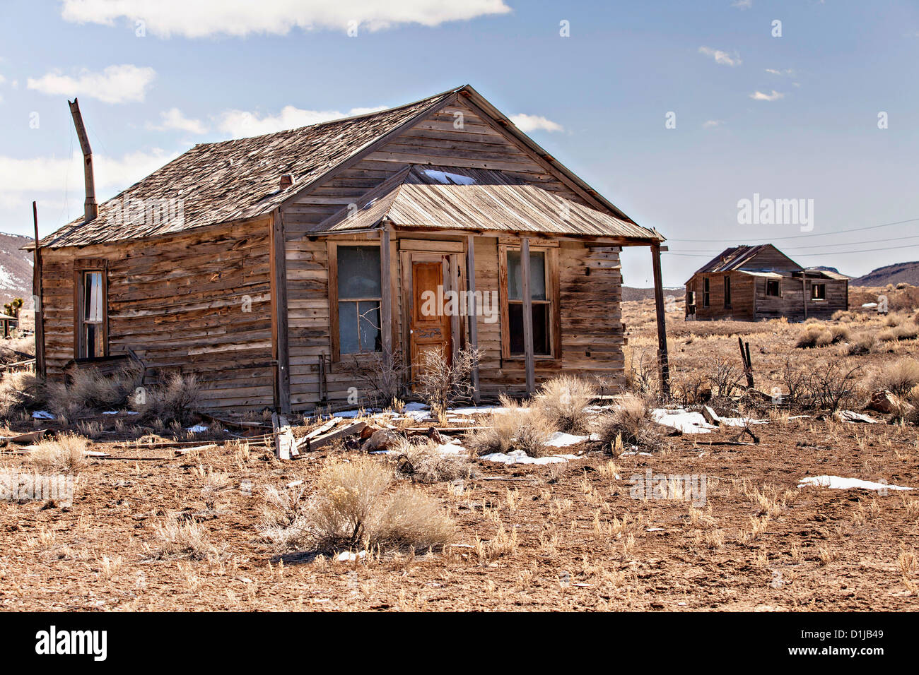 Old rusty cars and abandoned buildings in former gold mining boomtown ...