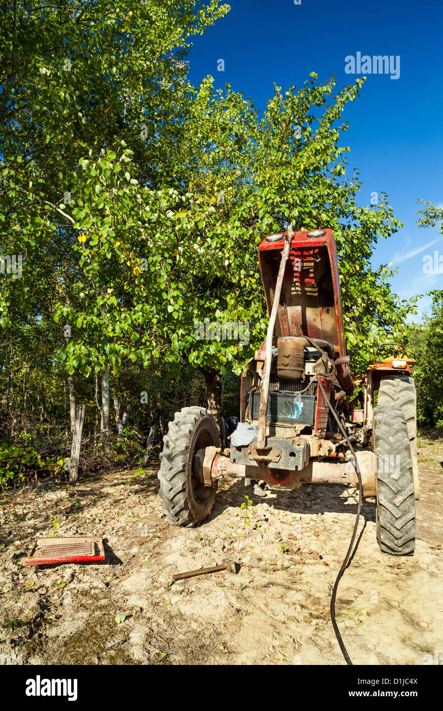 A tractor in the orchard, ready for repairing Stock Photo - Alamy