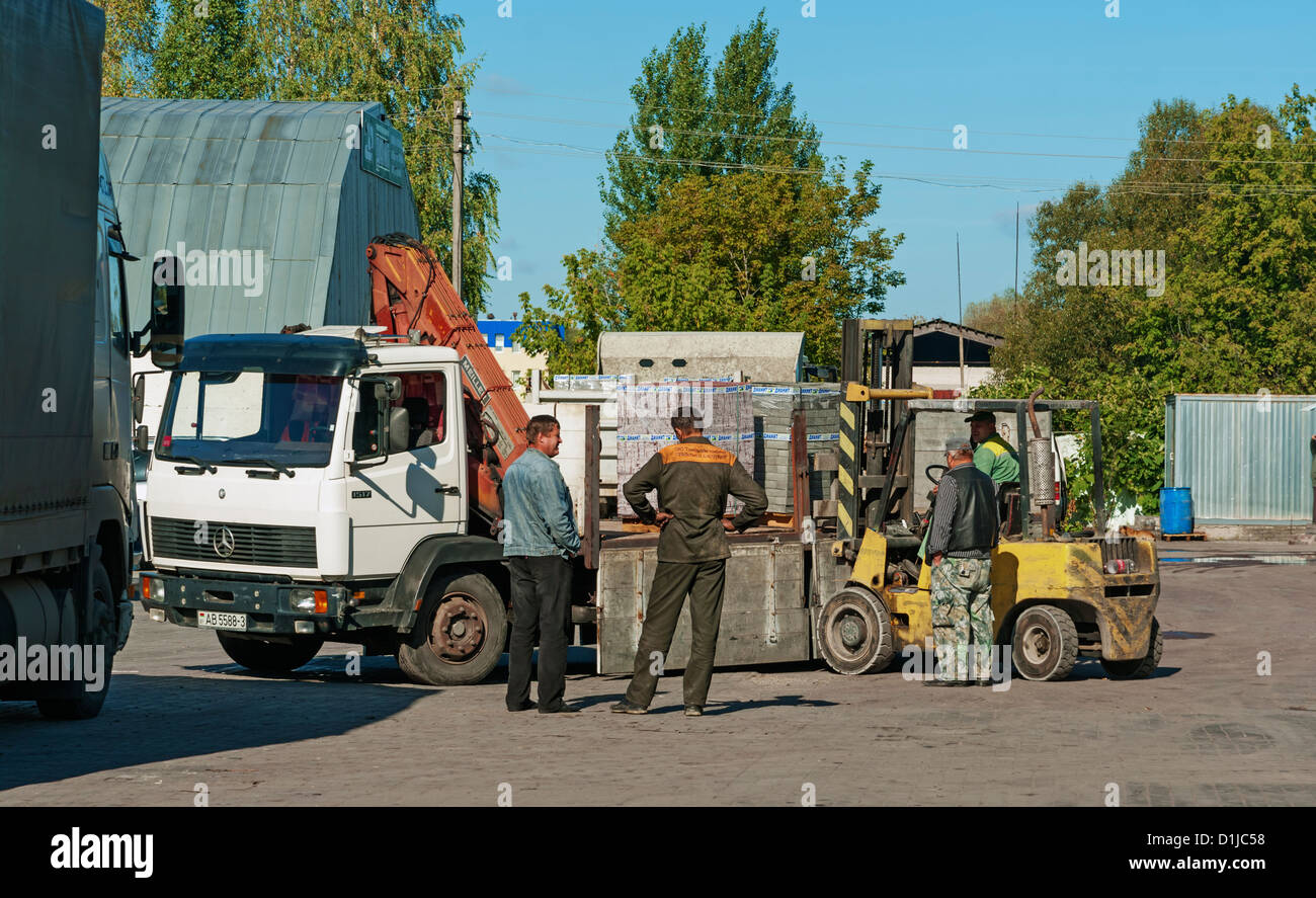 Warehouse platform for container with tiles for a roadwork. Loading of ...