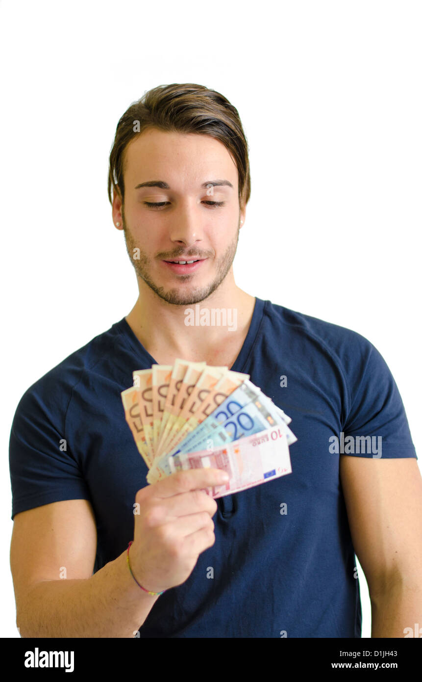 Successful and happy young man with euro bills (banknotes) in his hands ...