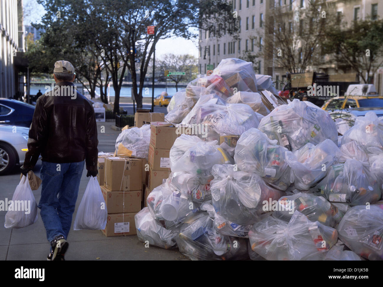 Man is carrying the garbage bag hi-res stock photography and images - Alamy