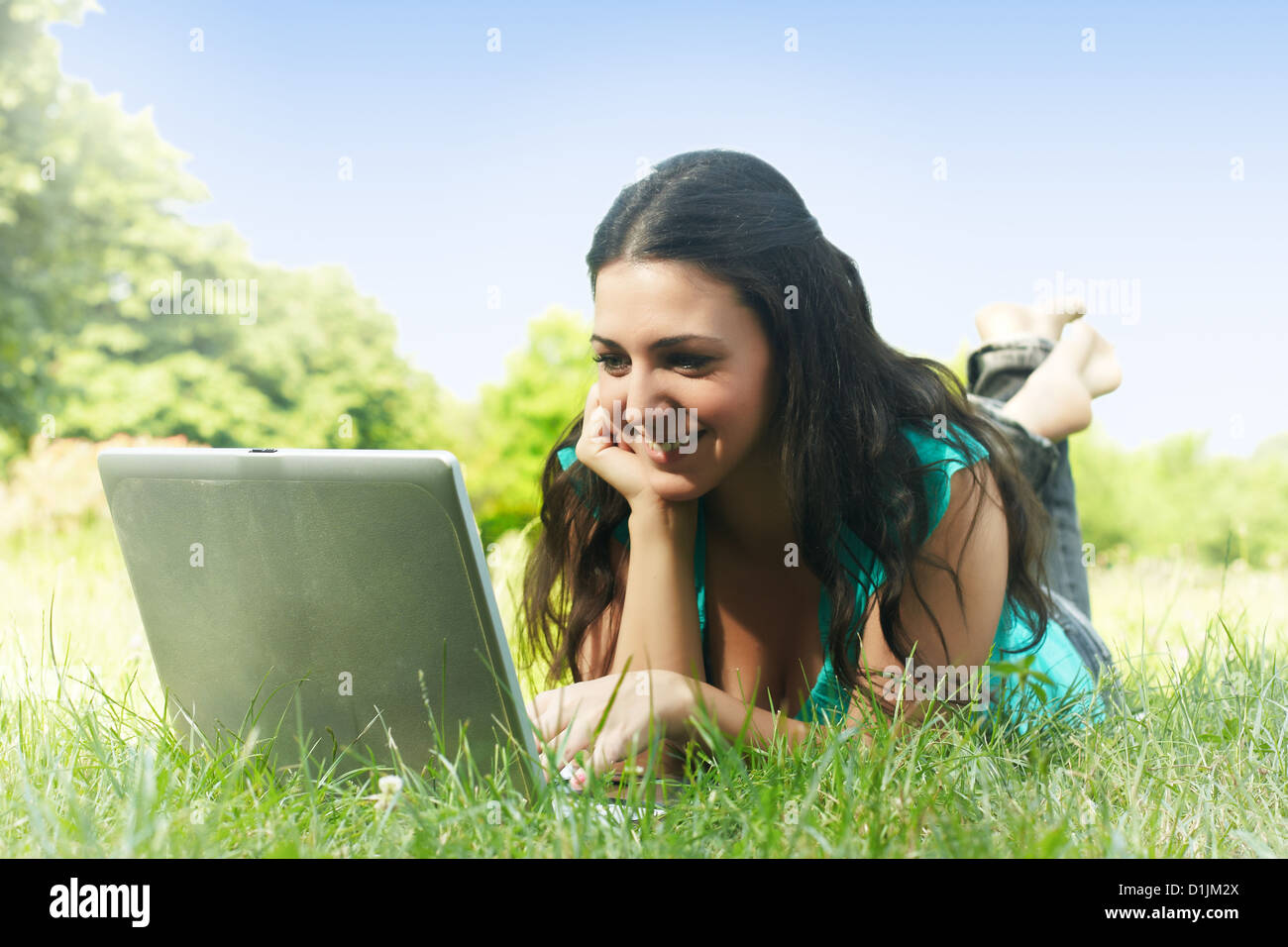 Happy student using laptop outdoors Stock Photo - Alamy