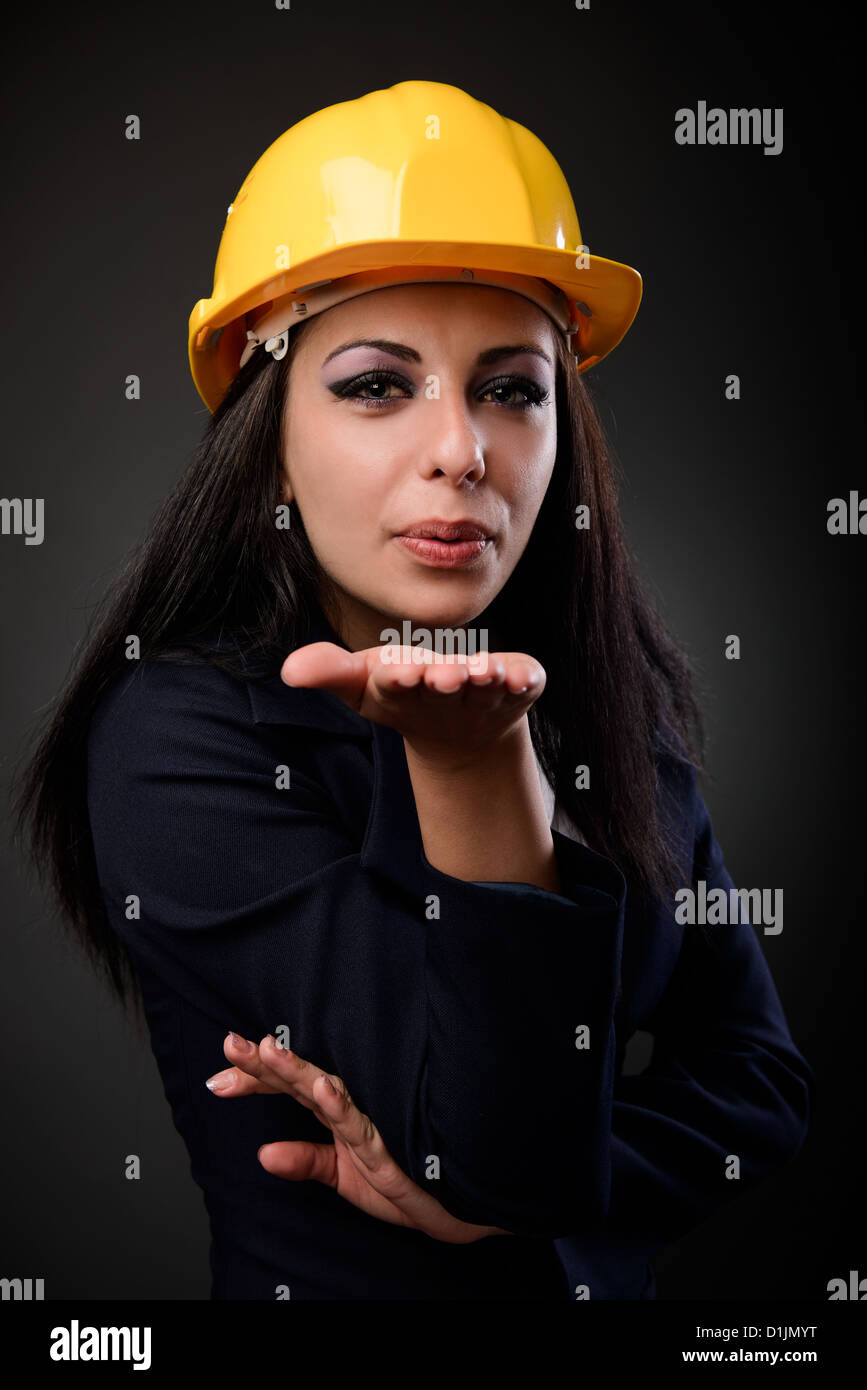 Young engineer lady with hardhat blowing kisses to the camera Stock ...