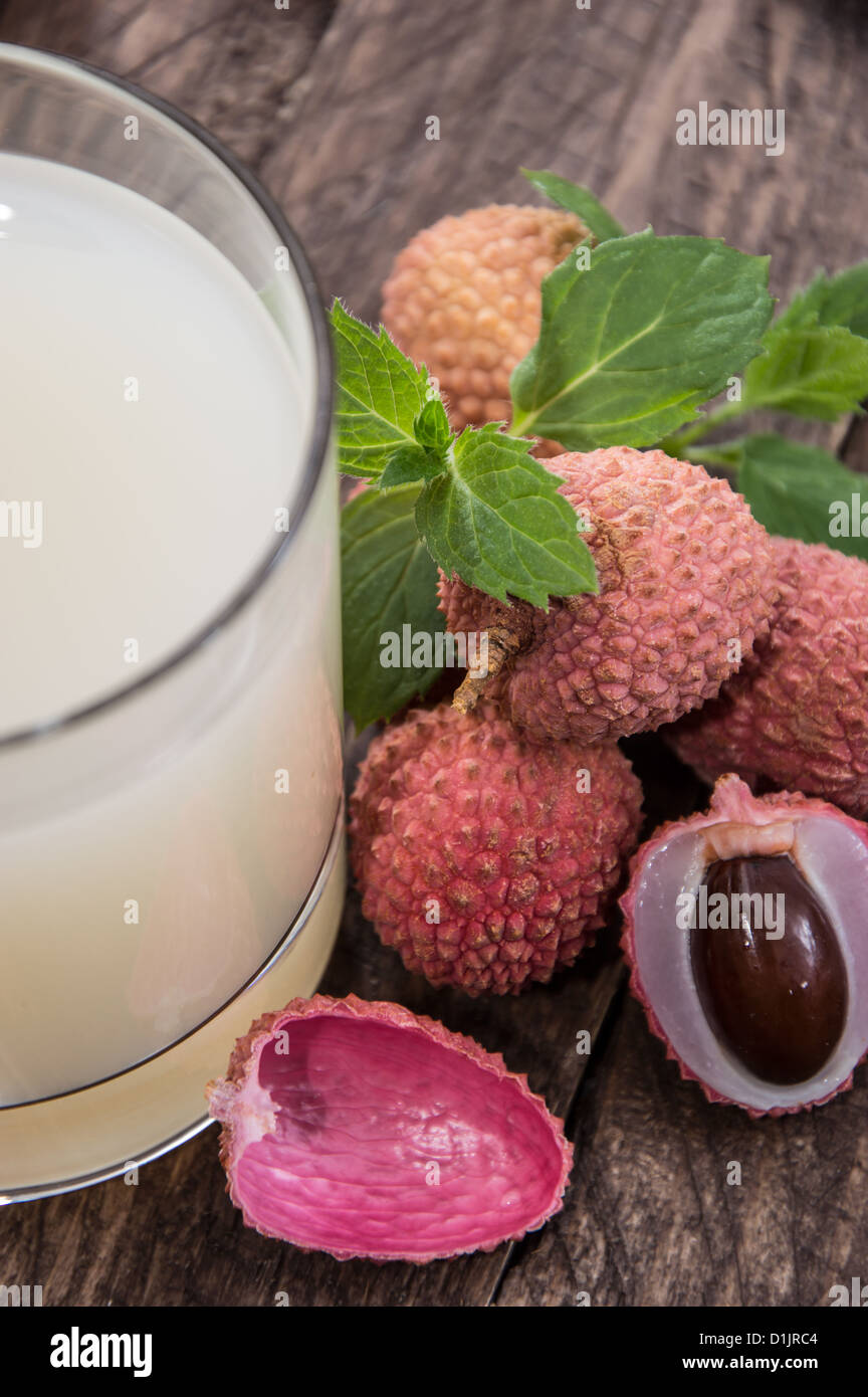 Lychee Juice with fresh fruits on wooden background Stock Photo - Alamy