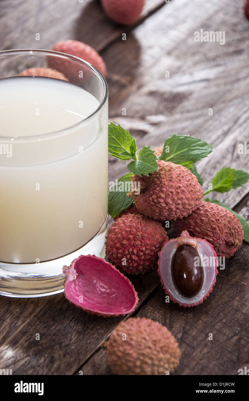 Lychee Juice with fresh fruits on wooden background Stock Photo - Alamy