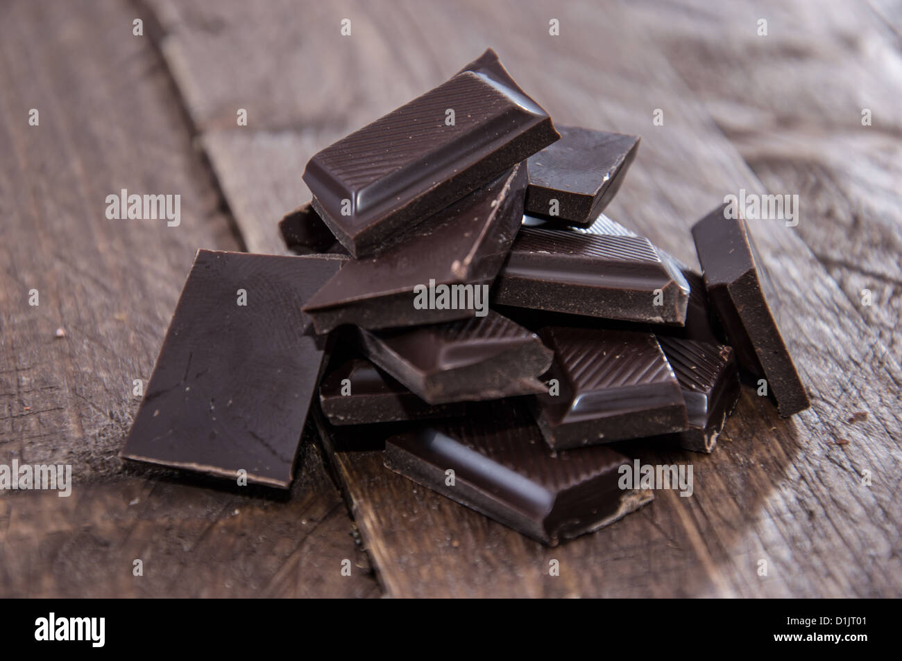 Heap of Chocolate on wooden background Stock Photo - Alamy