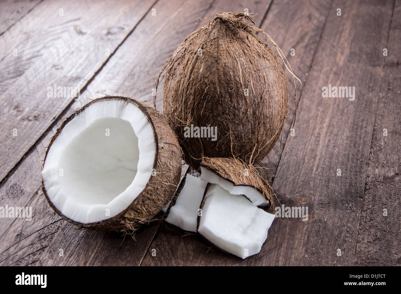 Cracked Coconut on wooden background Stock Photo - Alamy