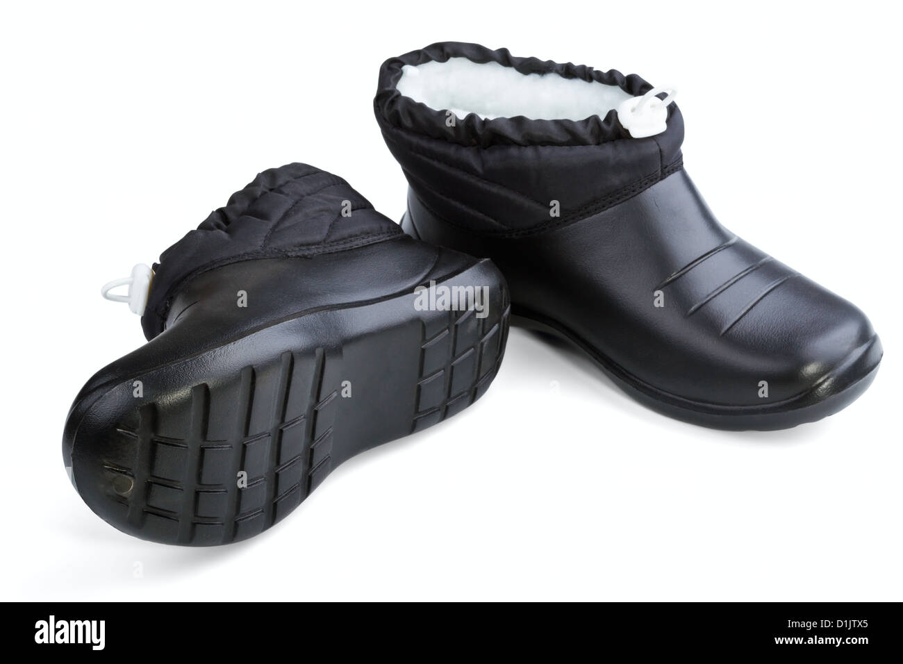Black rubber female shoes on a white background Stock Photo - Alamy