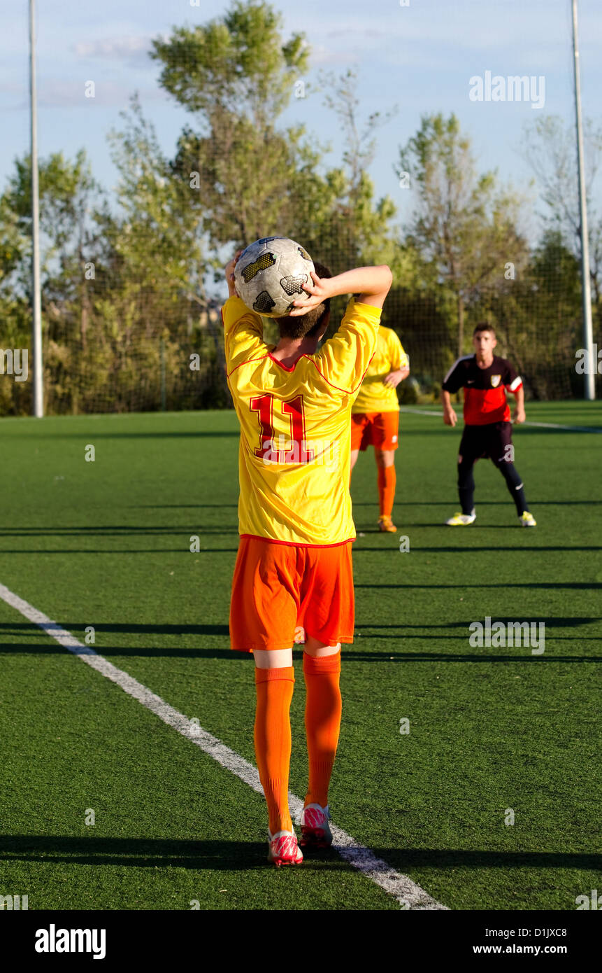 Boy playing football in match hi-res stock photography and images - Alamy