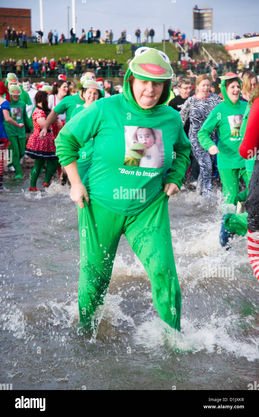 A woman dressed as Kermit the Frog takes part in the annual Boxing Day ...