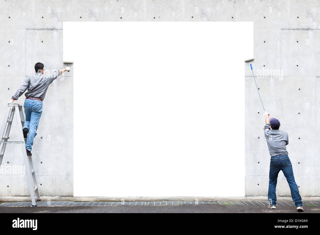 two workers are painting blank area on the wall Stock Photo - Alamy
