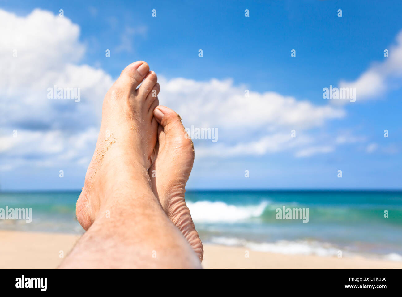 relaxed foot lying on the beach Stock Photo - Alamy