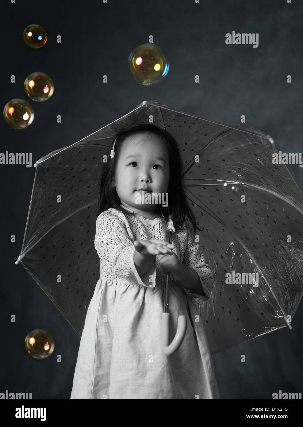The small Korean girl with a umbrella and soap bubbles Stock Photo - Alamy