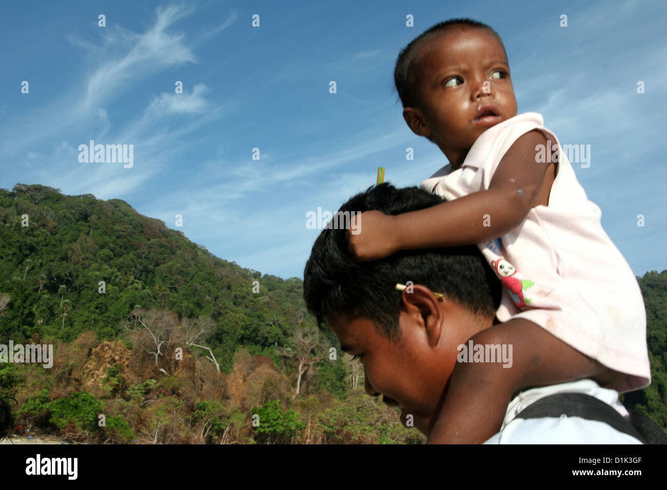 A Moken man with his child, sea gypsies of the Andaman sea in Koh Surin ...