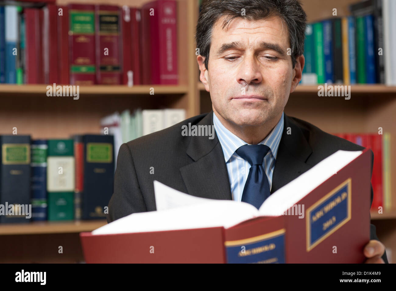 Environmental corporate portrait of solicitor, lawyer, attorney reading ...