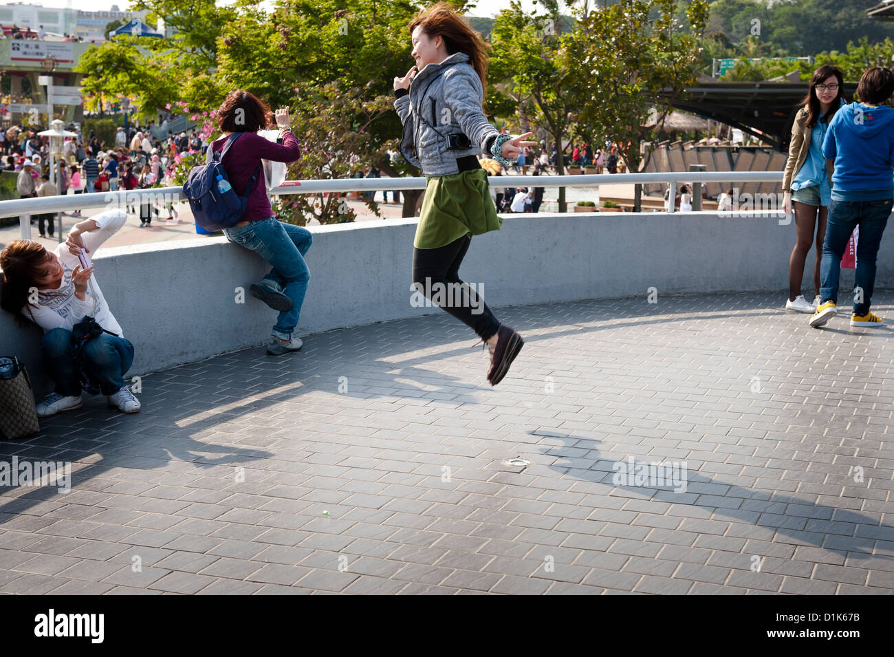 Young Chinese jump for photographs Stock Photo - Alamy