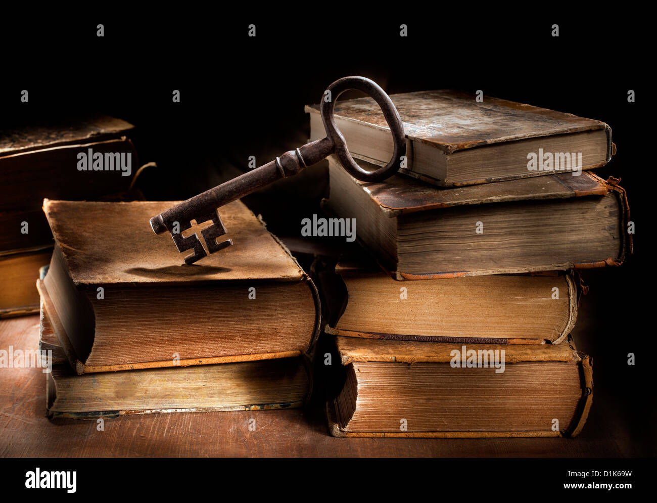 Conceptual still life image of old antique books and a big old key ...