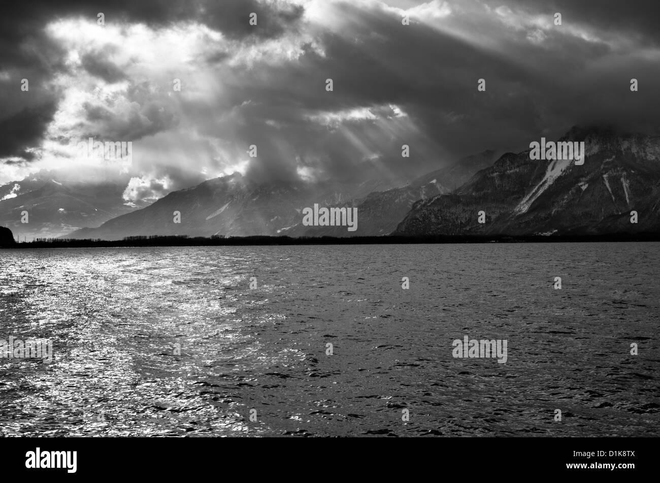 Black and White image of sunbeams through clouds on Lake Geneva and ...