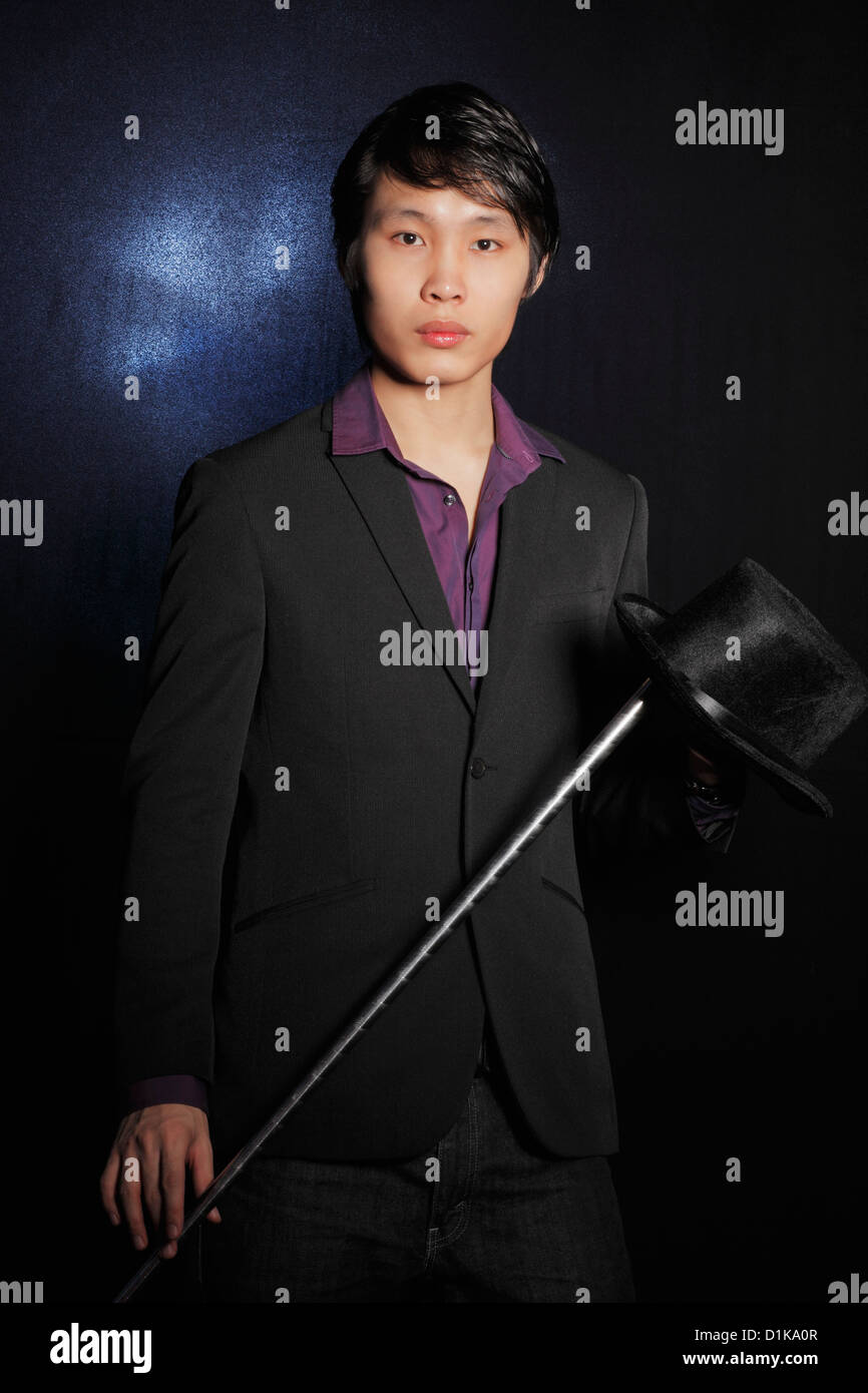 Portrait of a magician with his magic wand and hat Stock Photo - Alamy