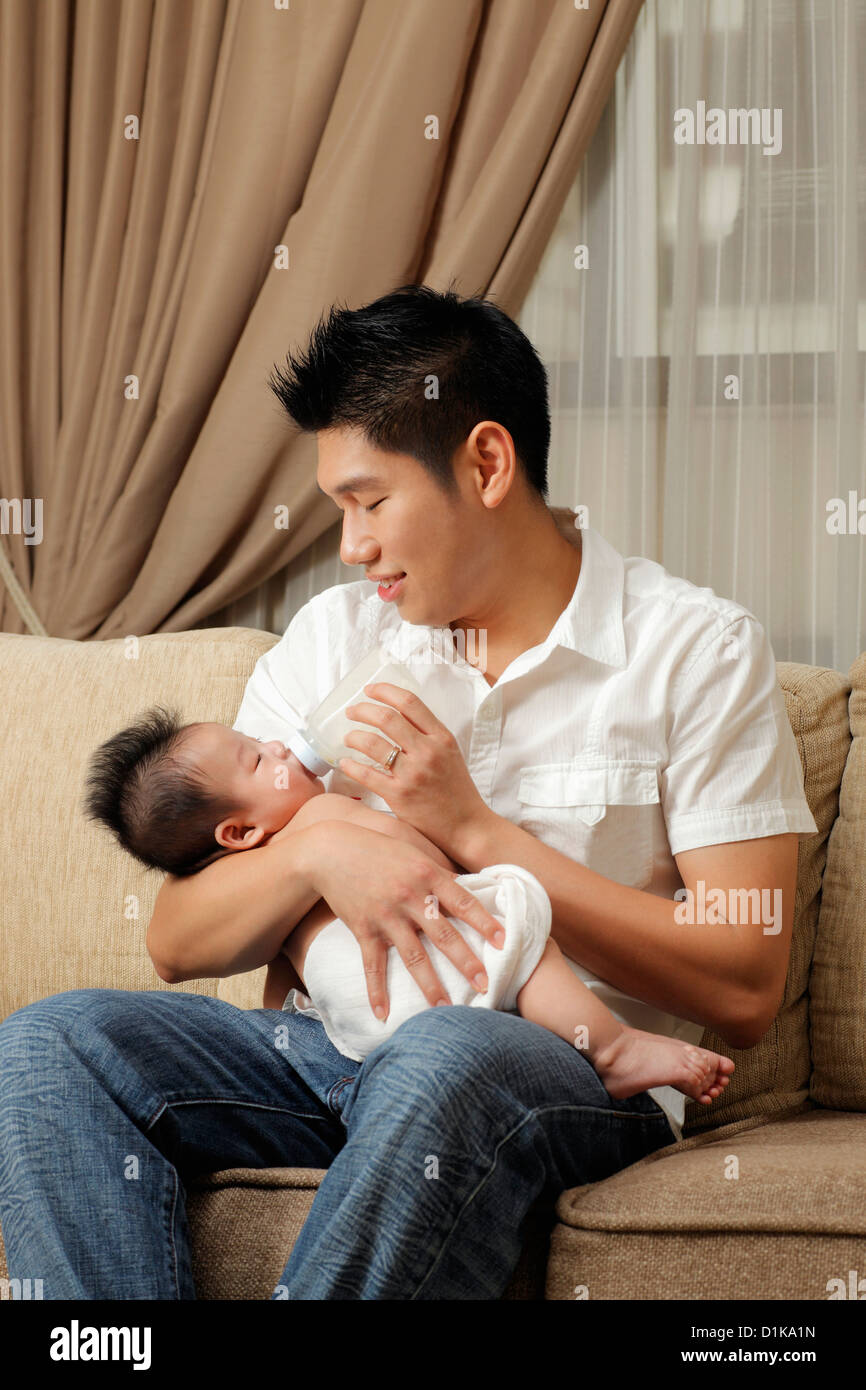 Man with a baby bottle of milk hi-res stock photography and images - Alamy