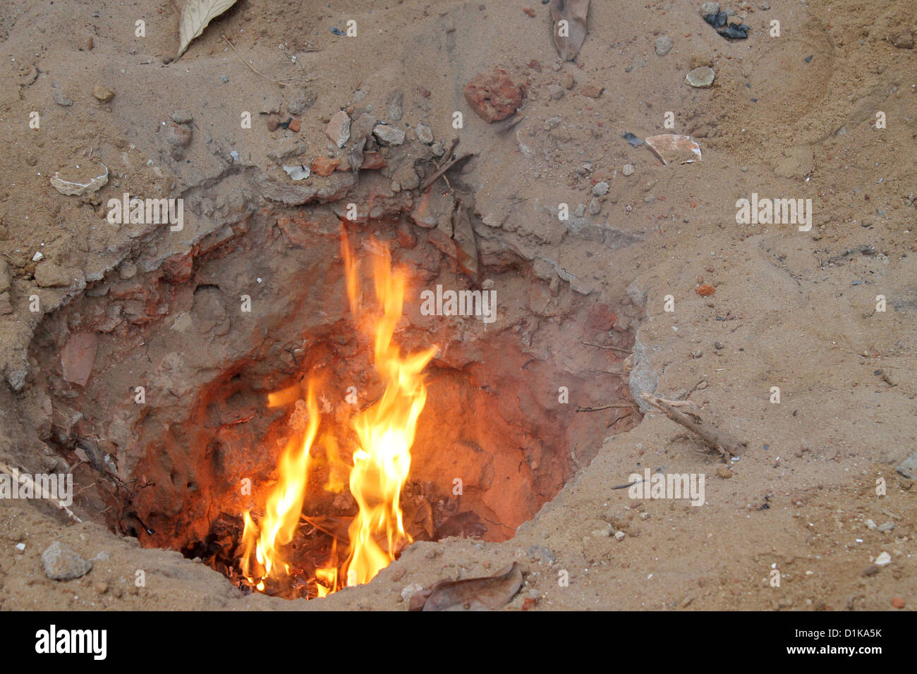 Leaves burnt inside a pit taken for planting a coconut Stock Photo - Alamy