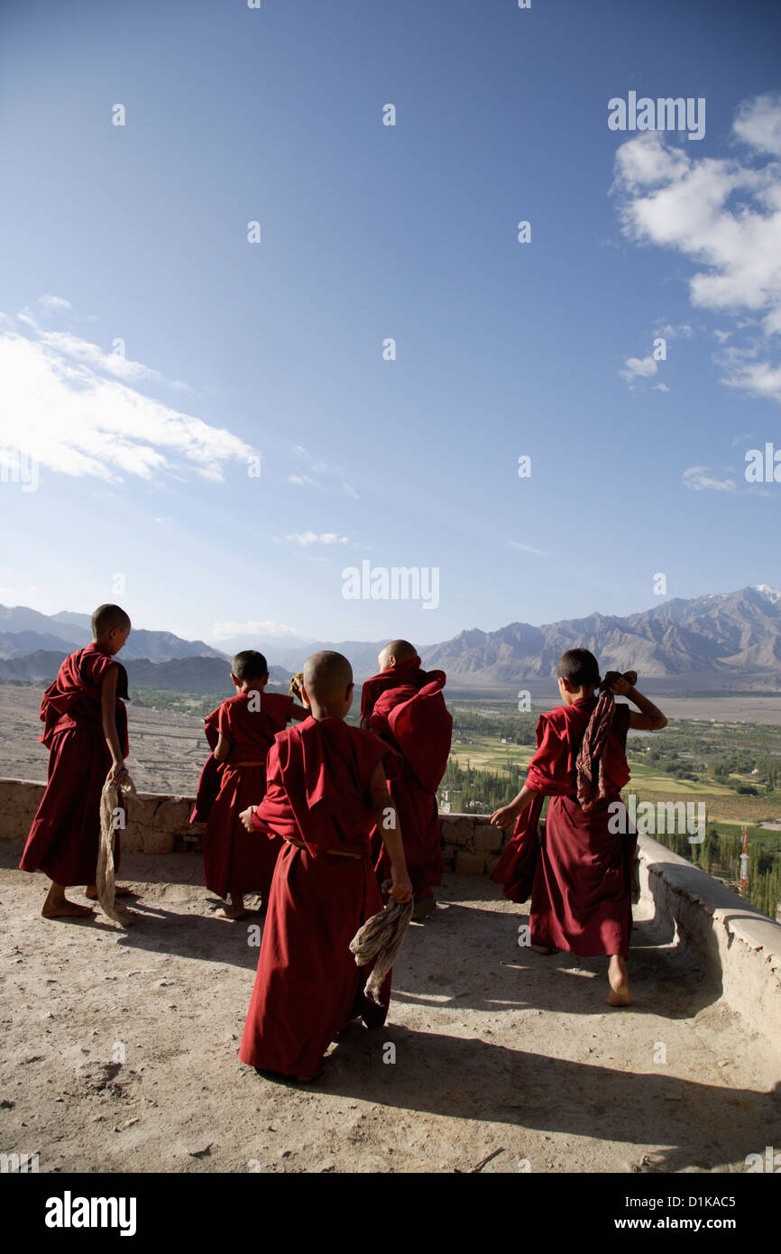 Rear view of young monks looking at the view, Likir Monastery, Ladakh ...